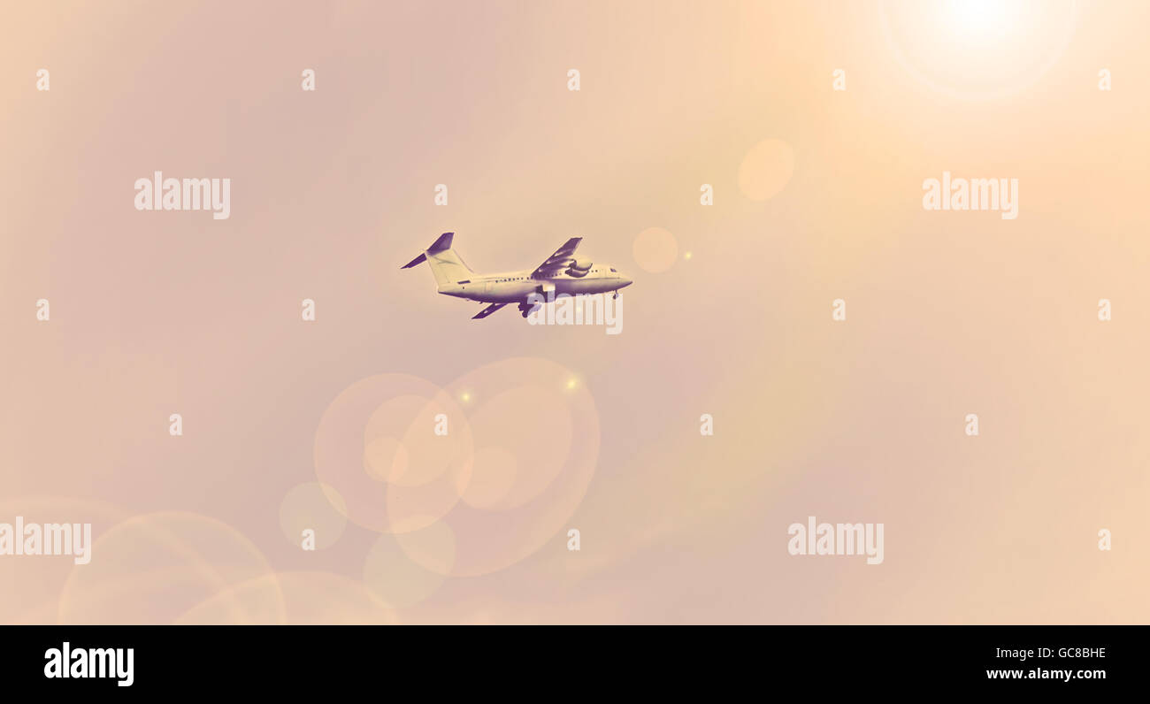 Flying plane in sunlight at clear sky Stock Photo - Alamy