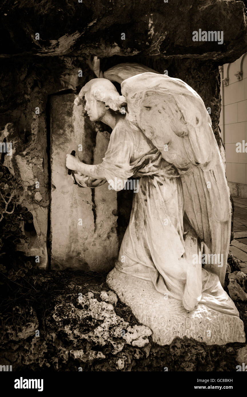sculpture of an angel opening a door Stock Photo - Alamy