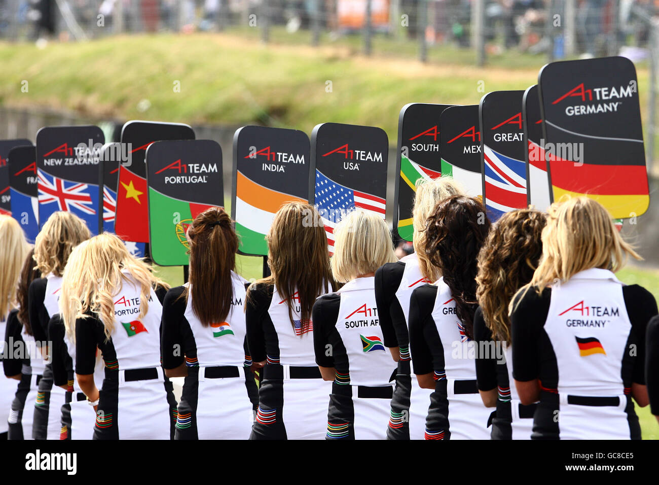 Grid girls line up holding flags competing nations hi-res stock ...