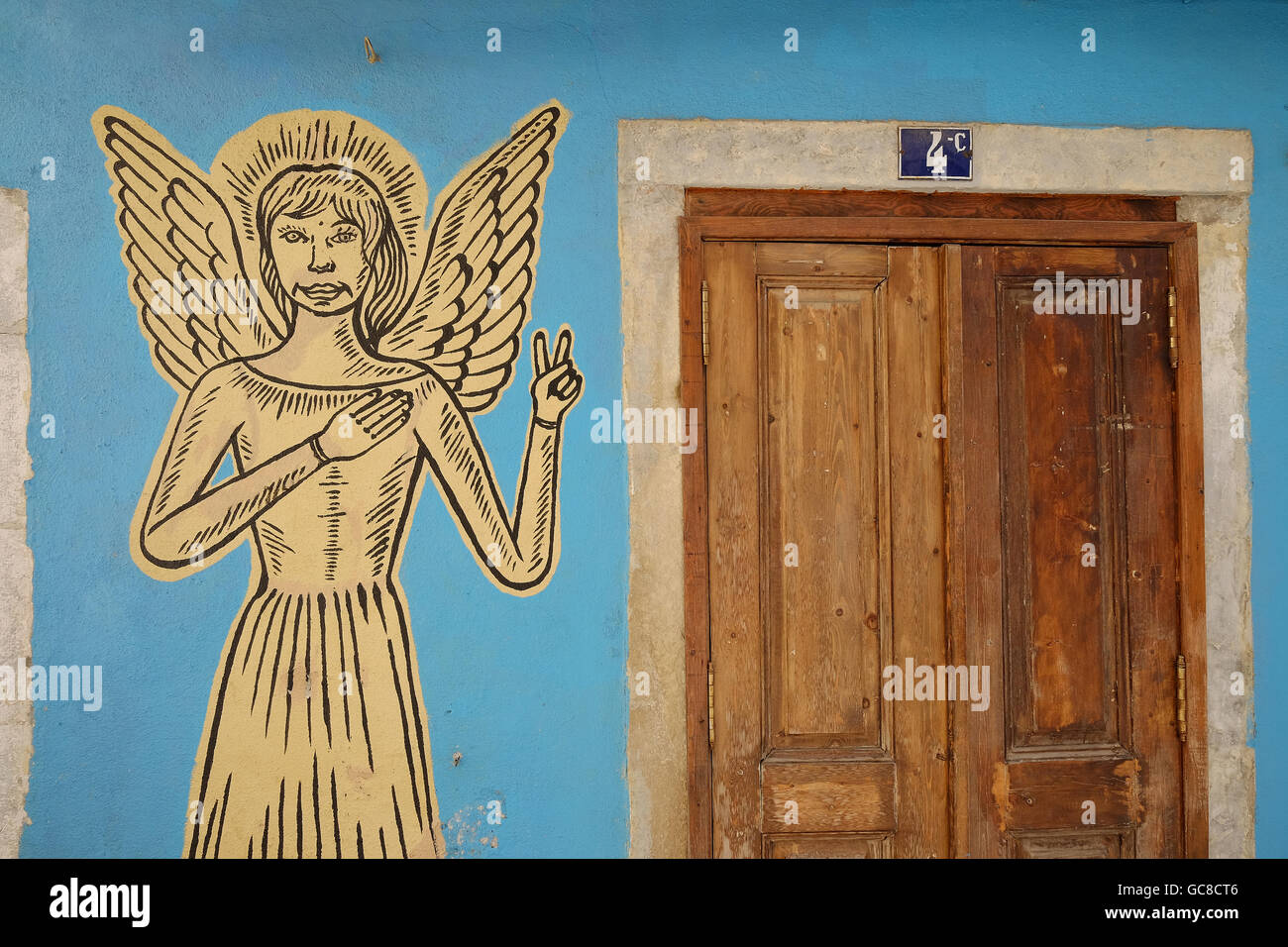 Gold angel on blue wall and wooden door Lisbon Stock Photo - Alamy