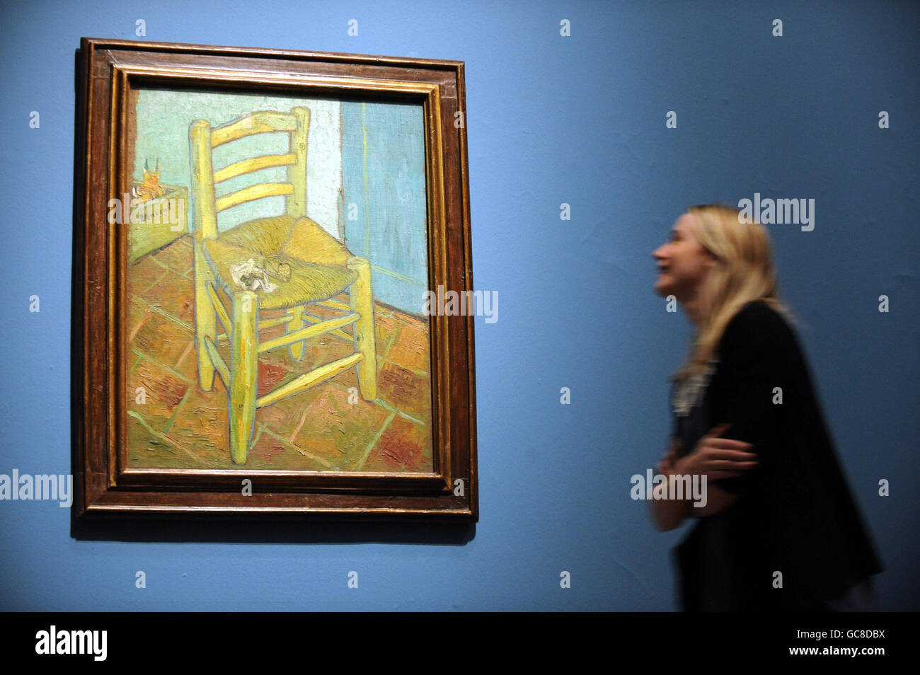 Gallery worker with Van Gogh's Chair, 1888-1889, at the preview of The ...
