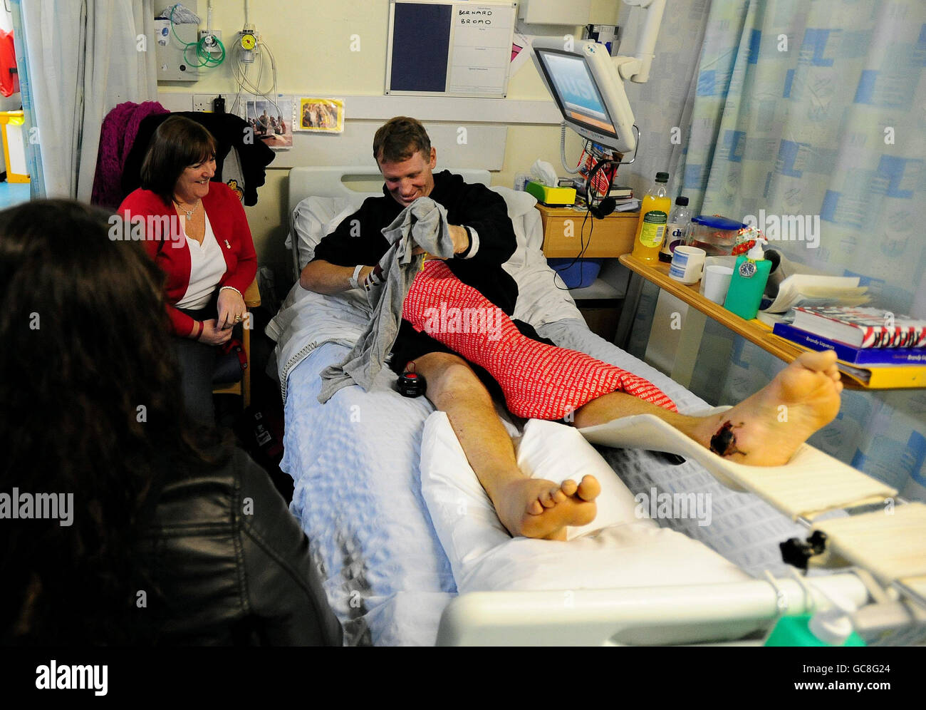 Major Bernie Broad looks at his Christmas stocking with wife Jan at ...