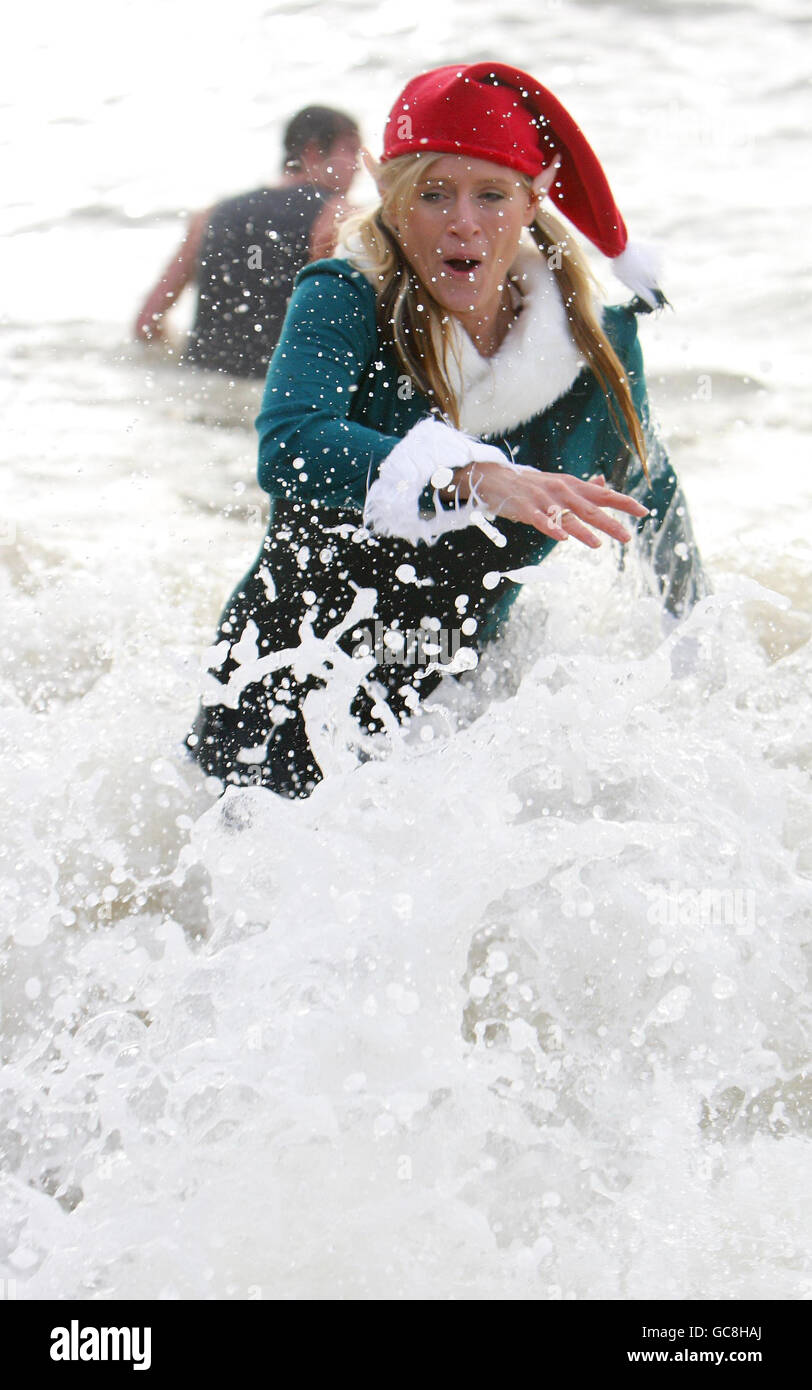 Dressed as an elf, Gill Attrill, from Brighton leaves the freezing sea ...