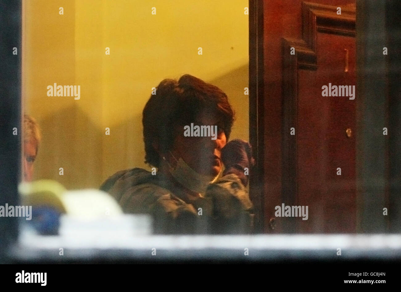 A forensics officer is seen through a window in a building in Mansfield ...