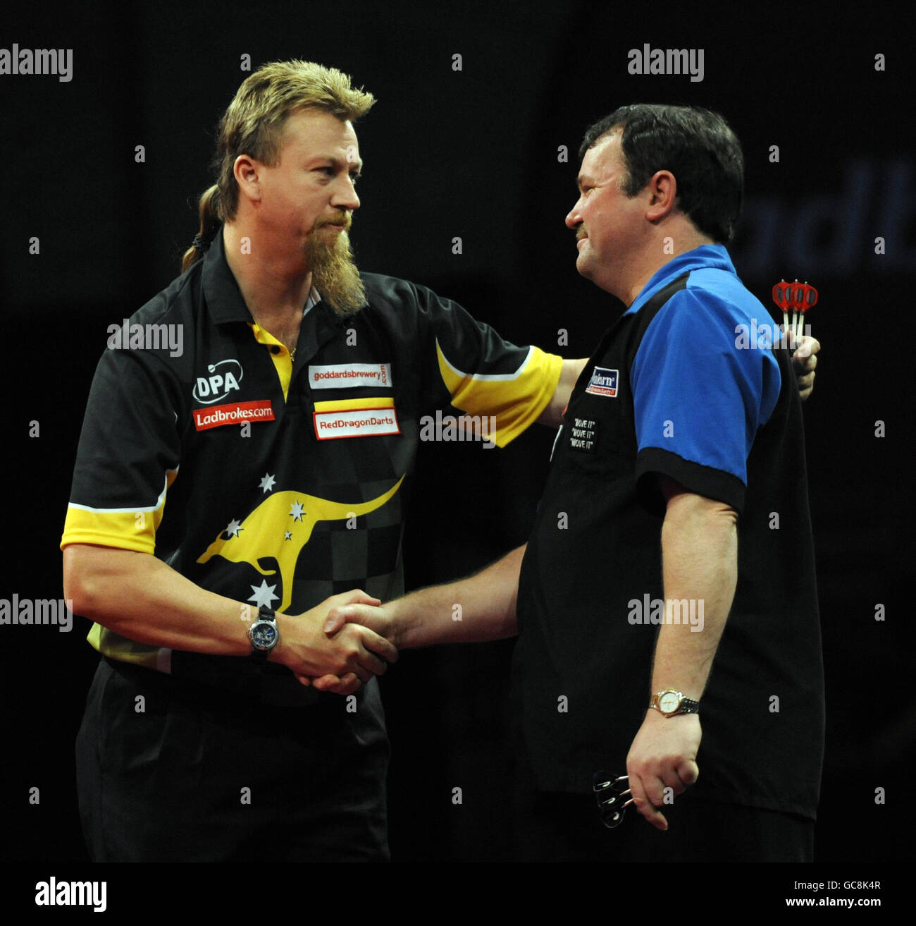 Australia's Simon Whitlock (left) celebrates defeating Terry Jenkins ...