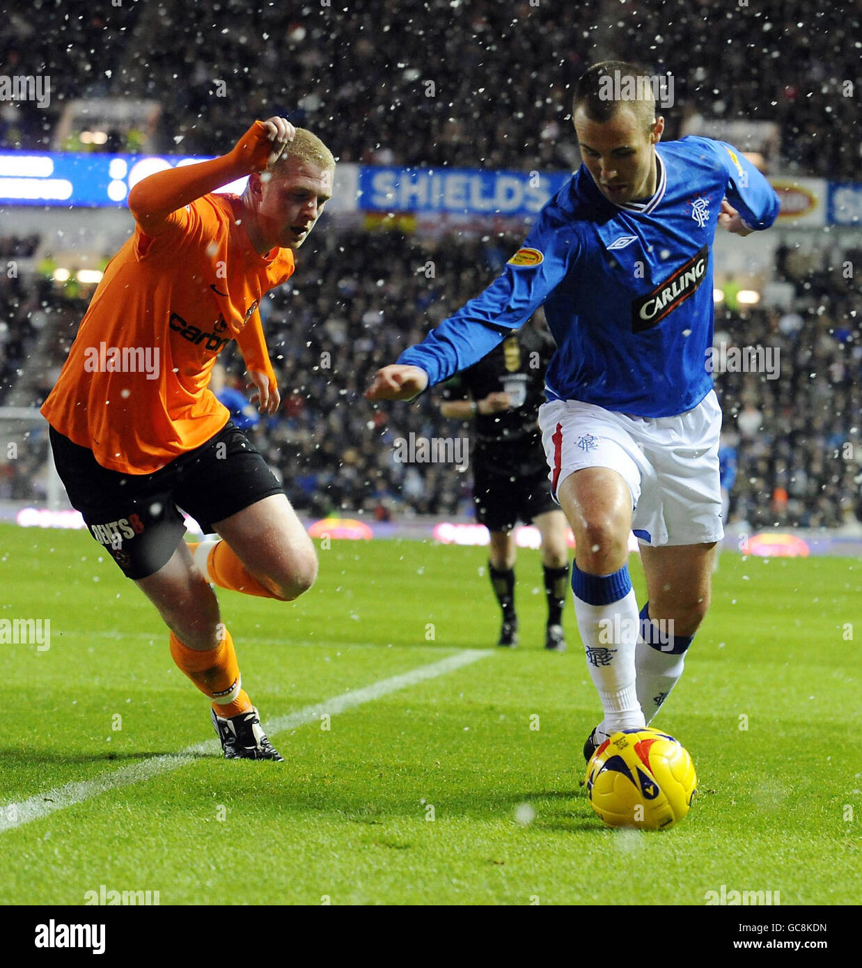 Rangers Kenny Miller is challenged by Dundee United's Garry Kenneth ...