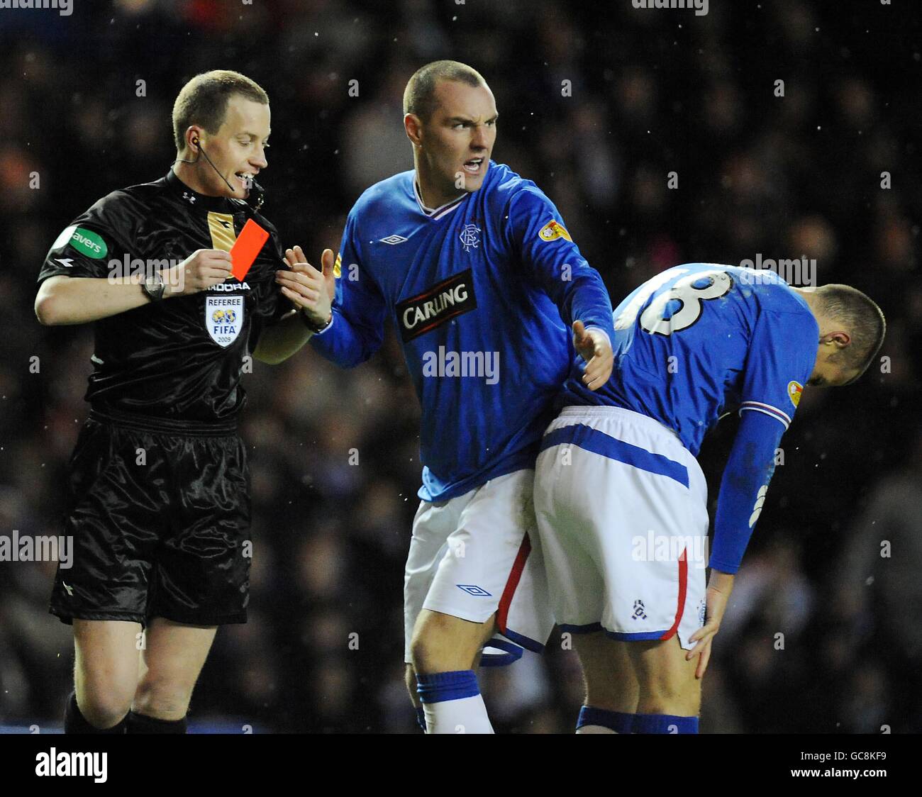 Rangers Kris Boyd (centre) questions referee, William Collum (left) for ...