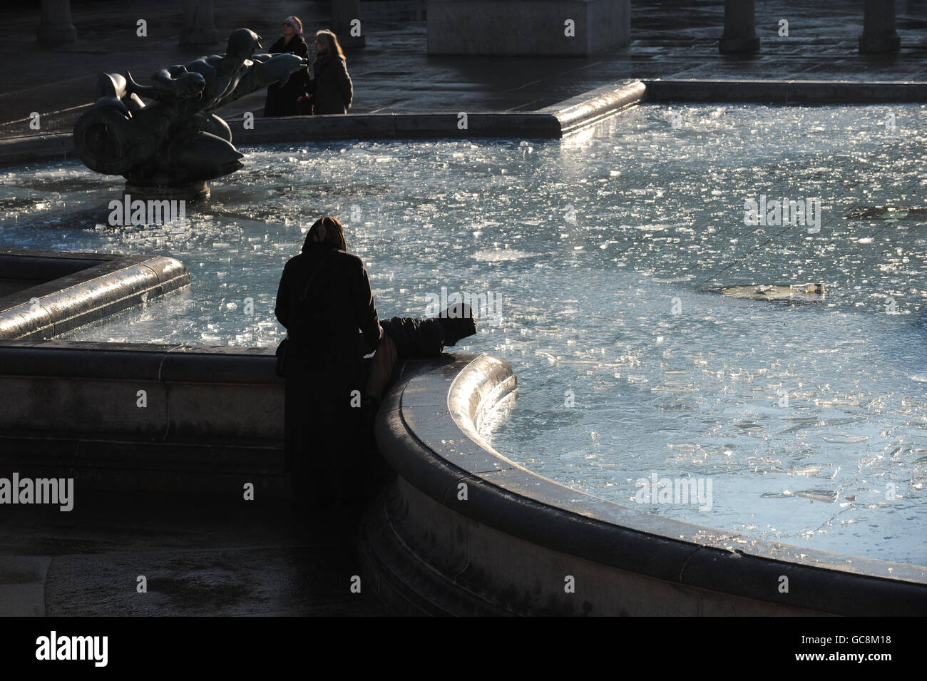 An iced over fountain pool in Trafalgar Square, London after a freezing ...