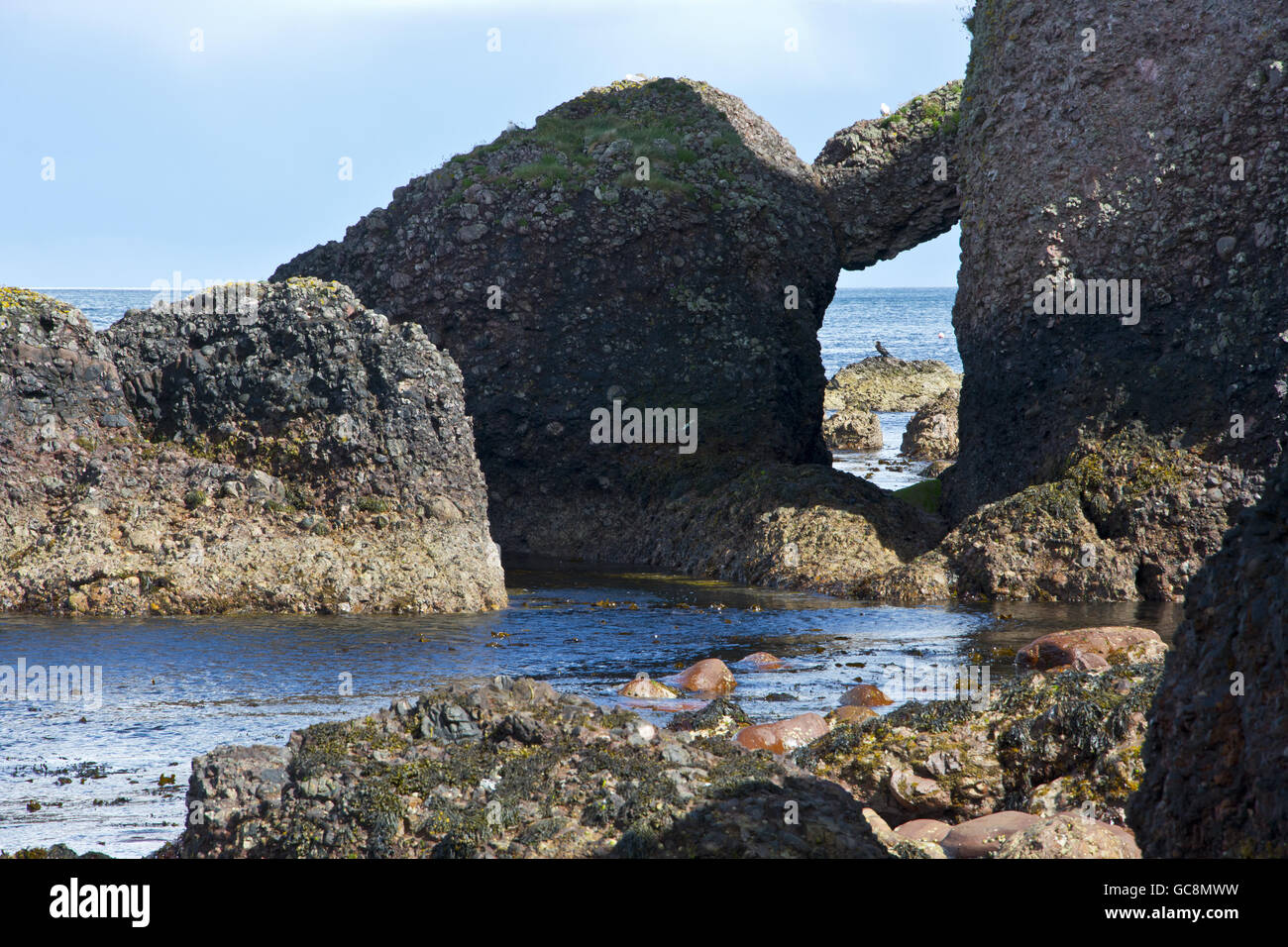 Cushendun cove caves Stock Photo - Alamy