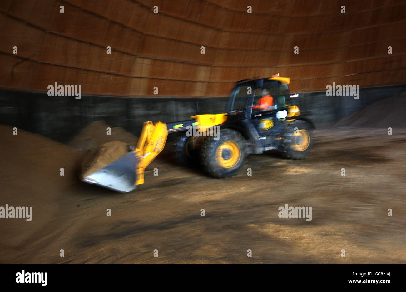 Tractors gather sand to be loaded onto gritting lorries for ...