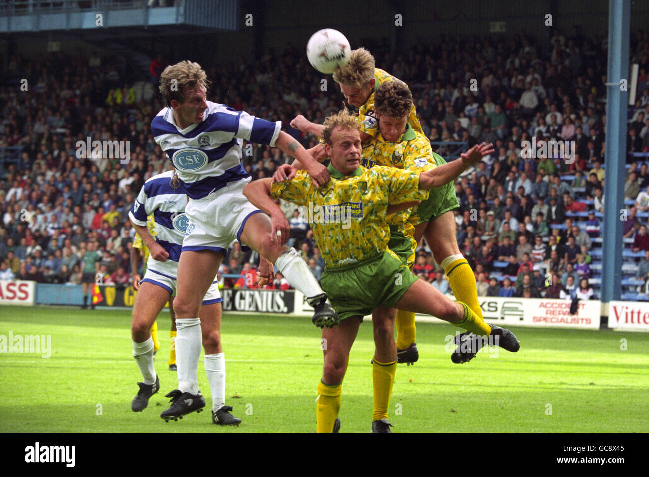 NORWICH CITY'S JOHN POLSTON HEADS THE BALL AWAY FROM QPR'S ALAN ...