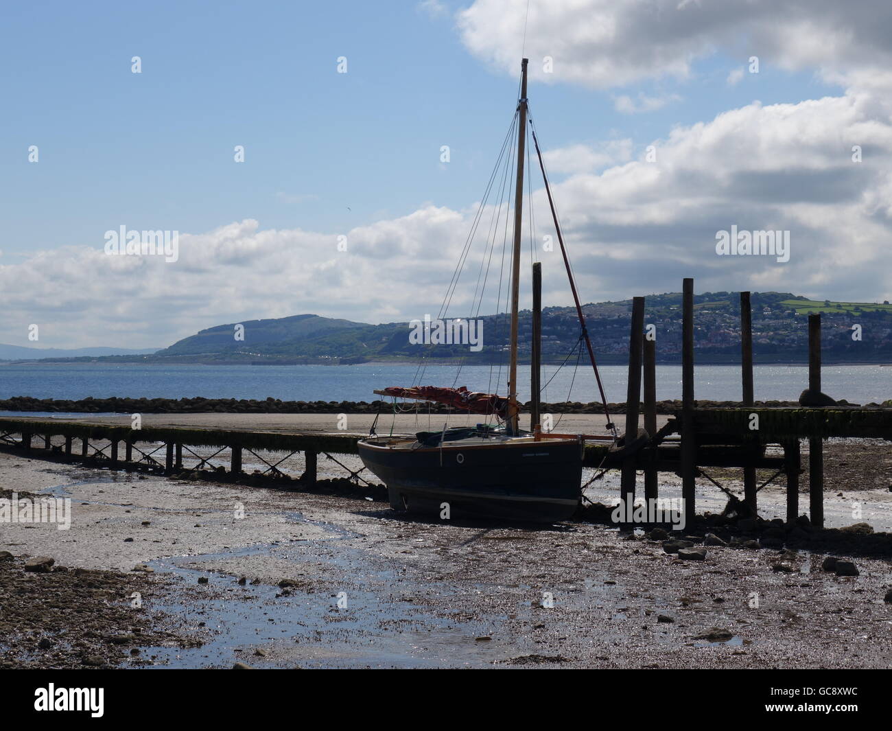 An old boat tied to a jetty Stock Photo - Alamy