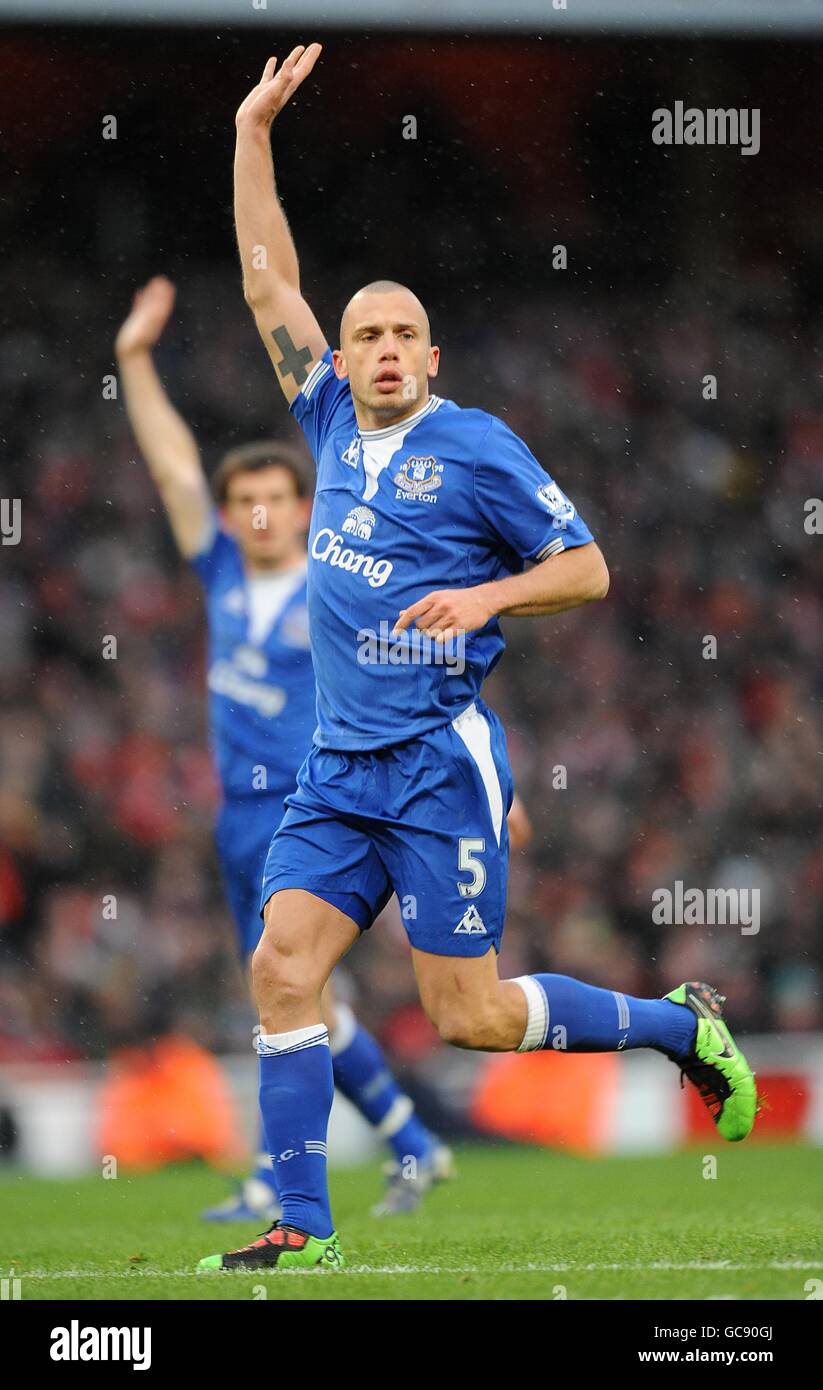 Everton's Johnny Heitinga (front) and Leighton Baines put their arms up ...