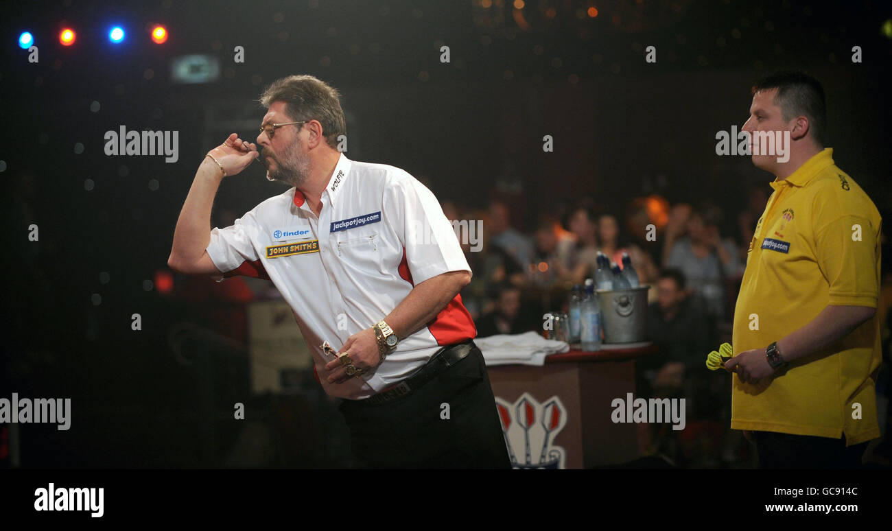 Martin Adams (left) in action as Dave Chisnell looks-on during the BDO ...