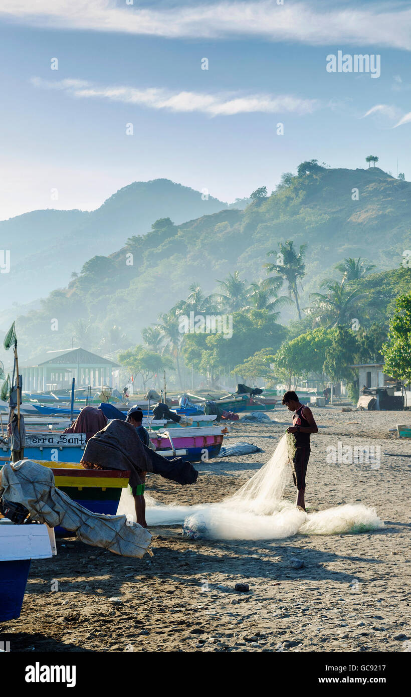 Timorese fishermen on tropical exotic dili beach in east timor at dawn ...