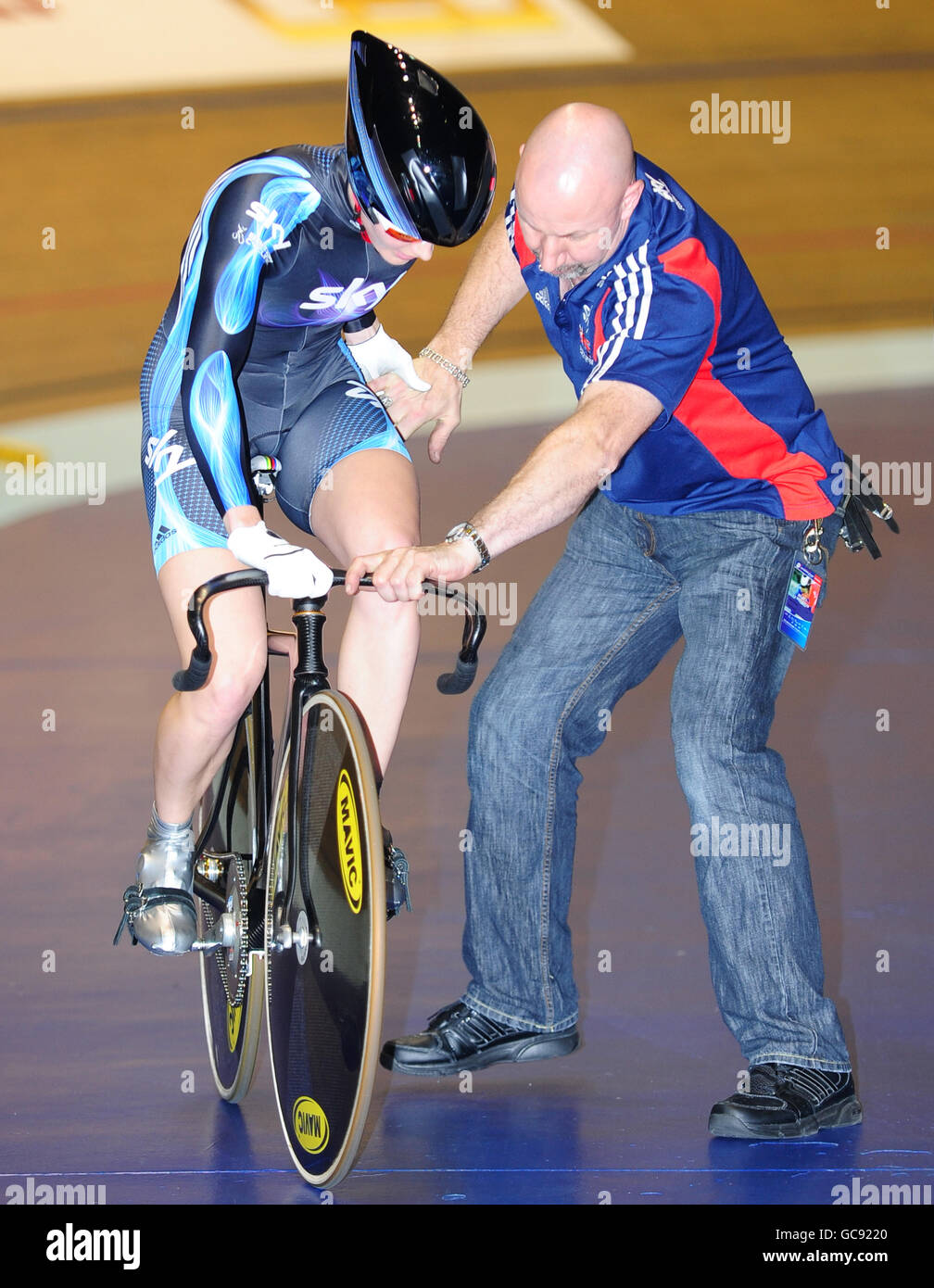 Team Sky's Victoria Pendleton is assisted in stopping her bike after ...