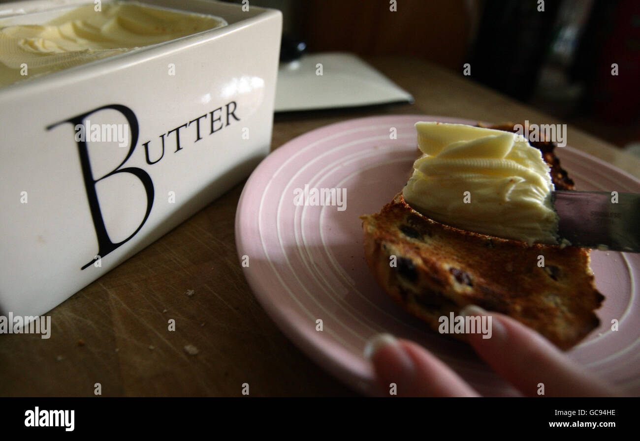 Butter being spread on hot cross bun. Butter should be banned in a bid ...