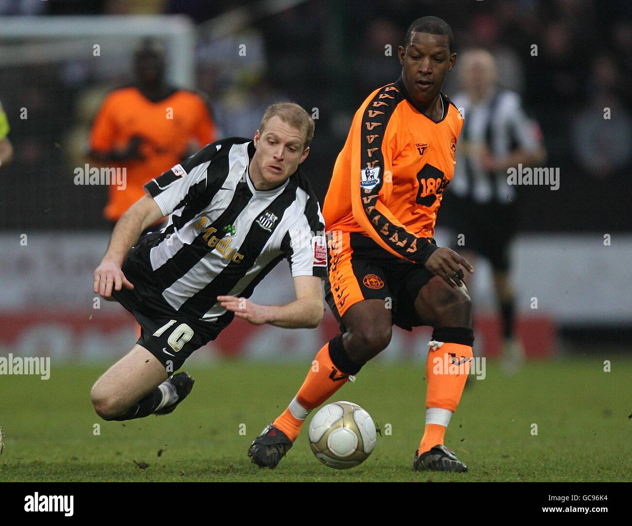 Notts County's Neal Bishop (left) and Wigan Athletic's Titus Bramble ...