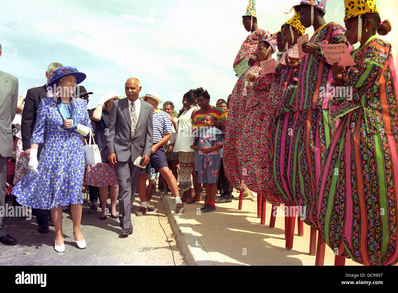 Queen Elizabeth II smiles at welcome messages displayed by colourful ...