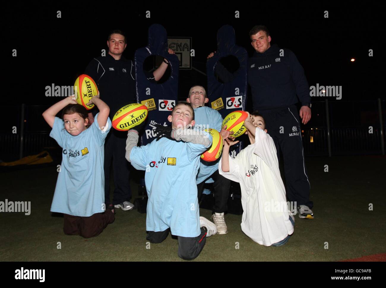 Jon Welsh and Moray Low take kids in a session of street rugby during ...