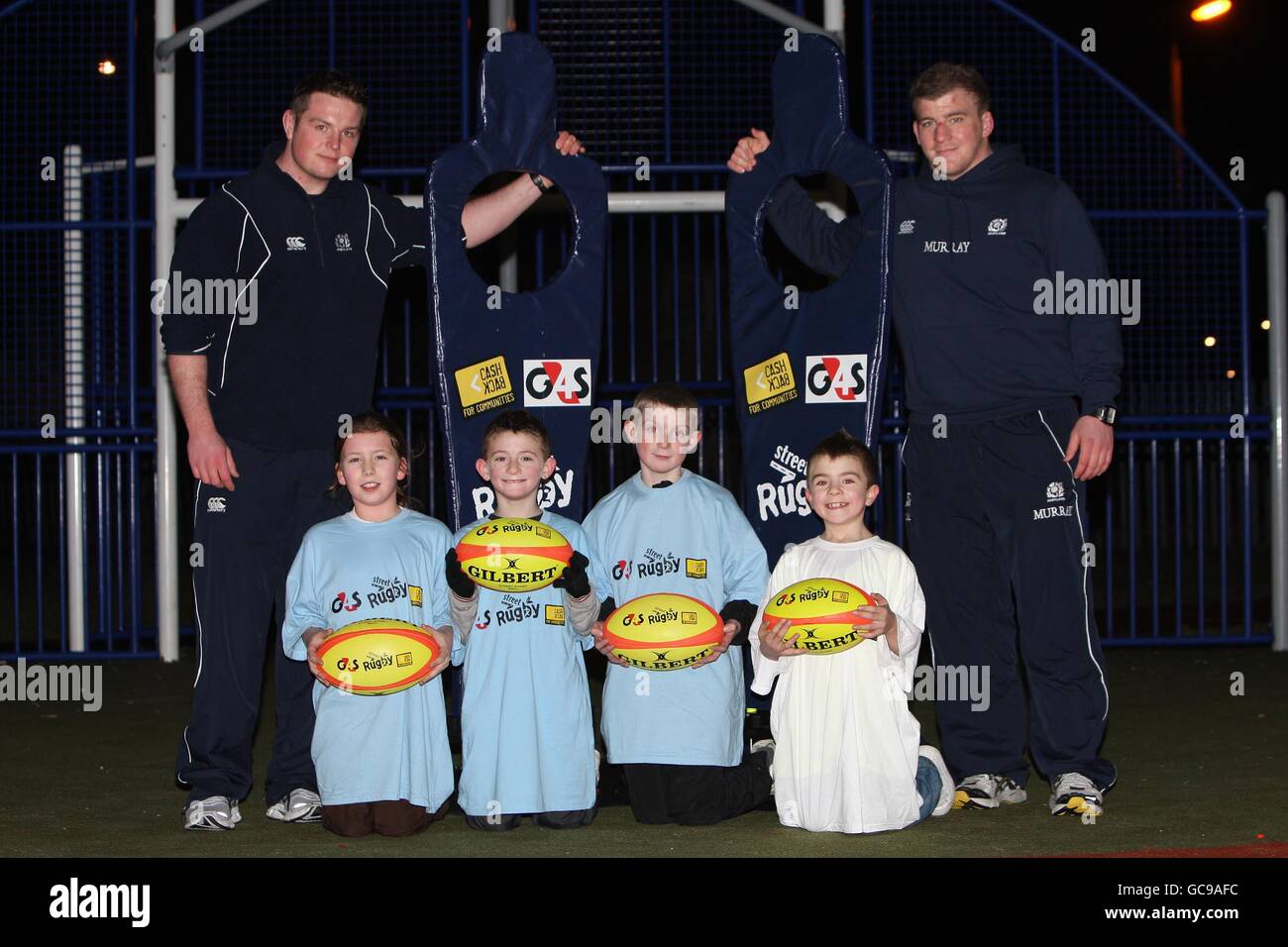 Jon Welsh and Moray Low take kids in a session of street rugby during ...