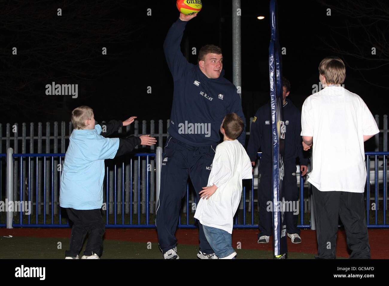 Jon Welsh and Moray Low take kids in a session of street rugby during ...