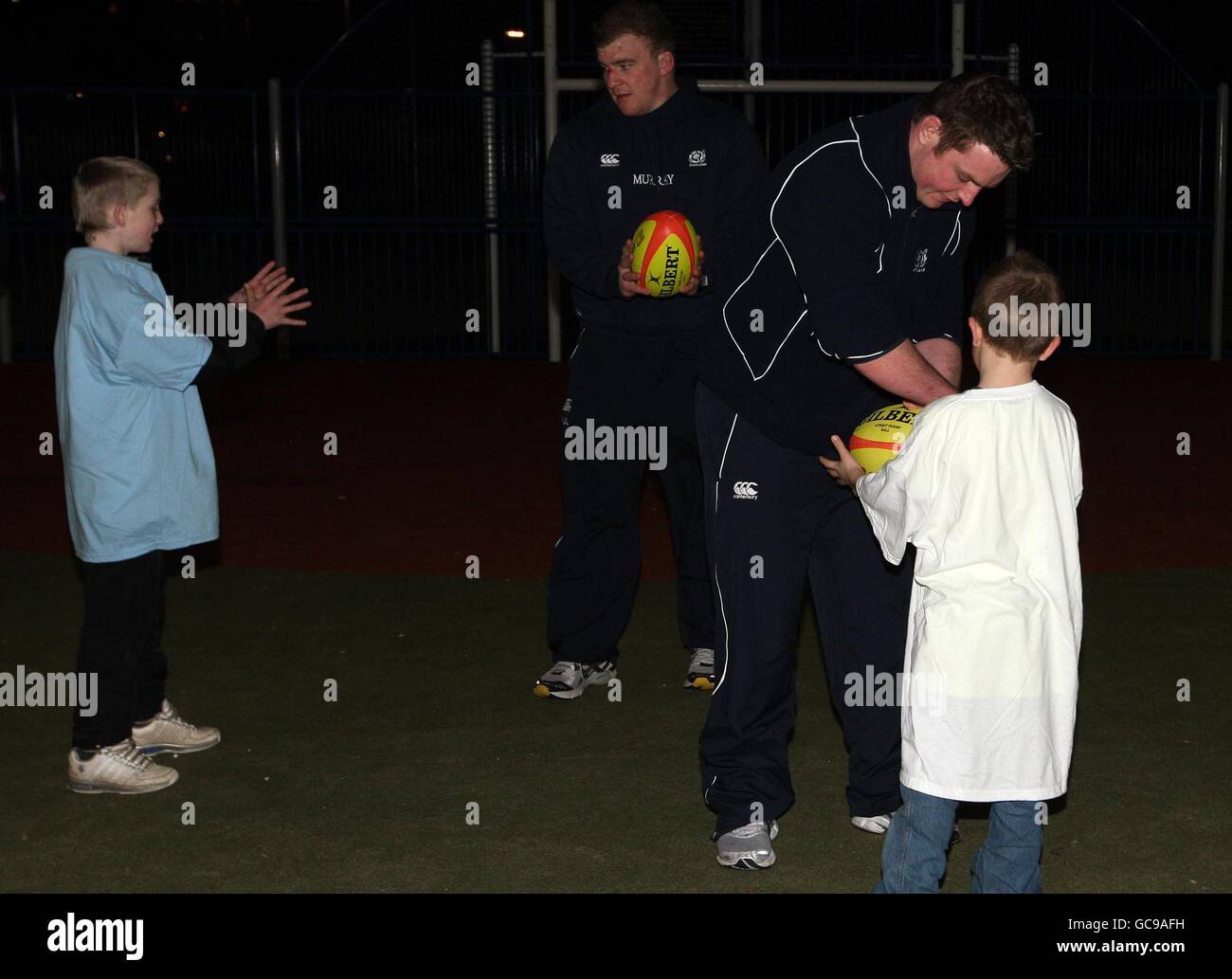 Jon Welsh and Moray Low take kids in a session of street rugby during ...