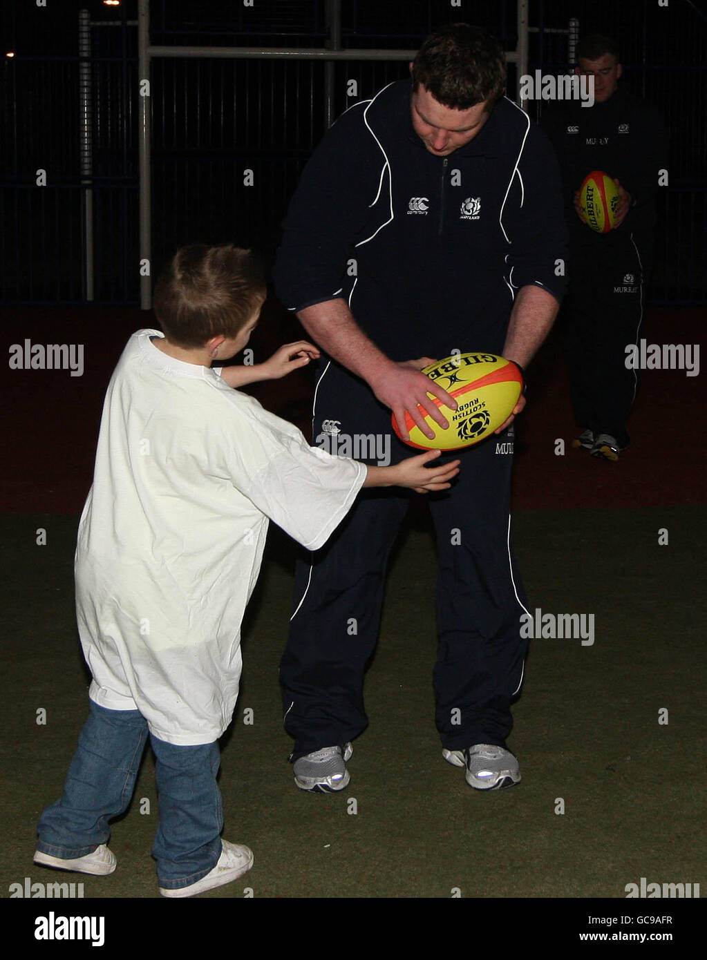 Jon Welsh and Moray Low take kids in a session of street rugby during ...
