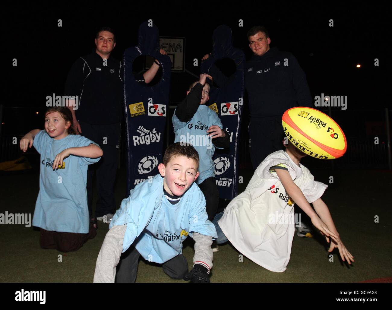 Jon Welsh and Moray Low take kids in a session of street rugby during ...