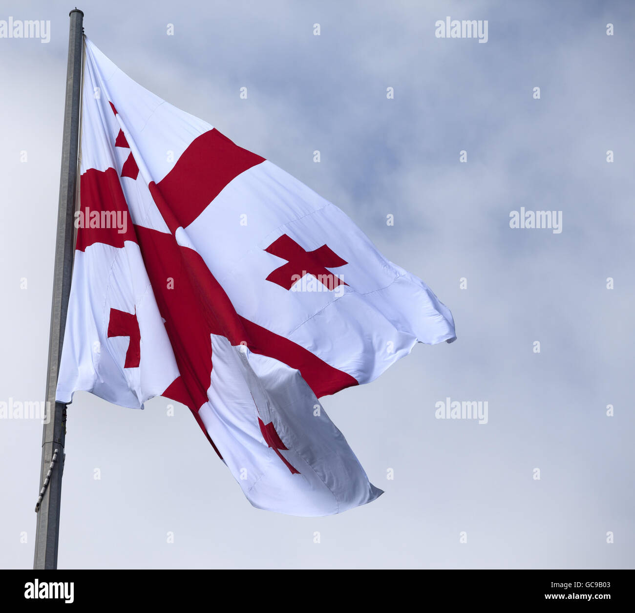 Flag of Georgia and cloudy sky at gray windy day Stock Photo - Alamy