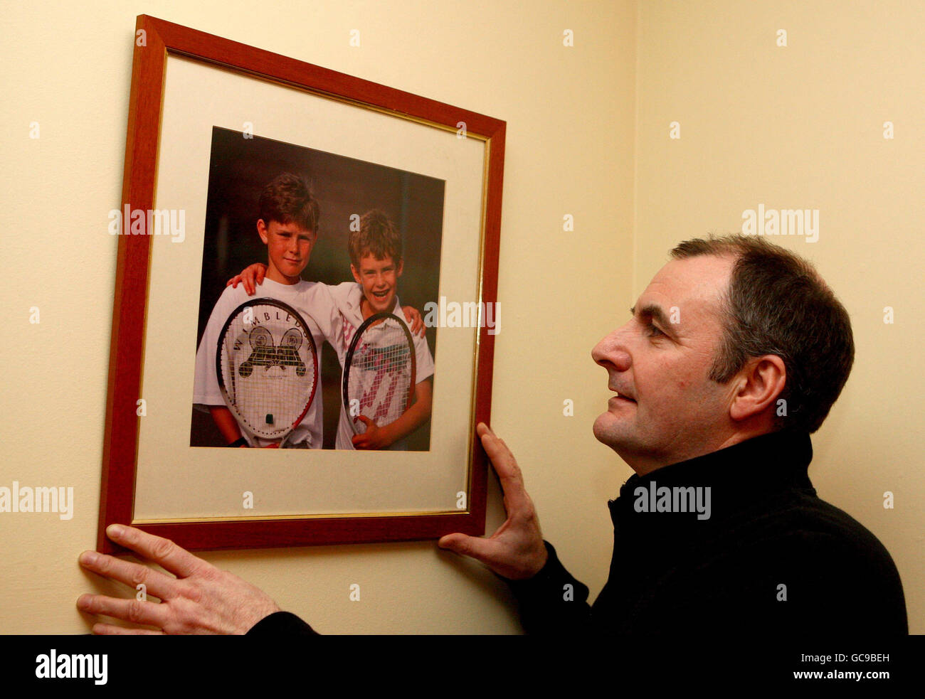 Andy Murray's father Will Murray looks at a picture of his sons Jamie ...