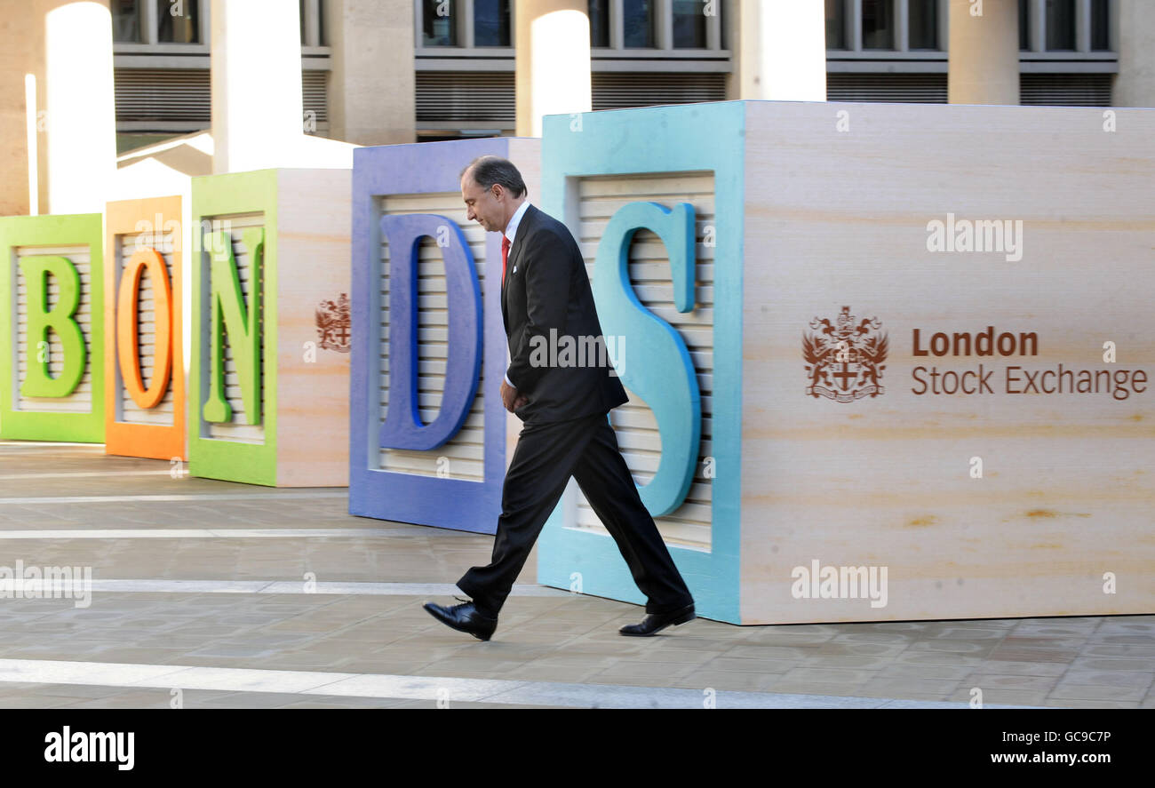Chief Executive of the LSE, Xavier Rolet, poses bedside signage outside ...