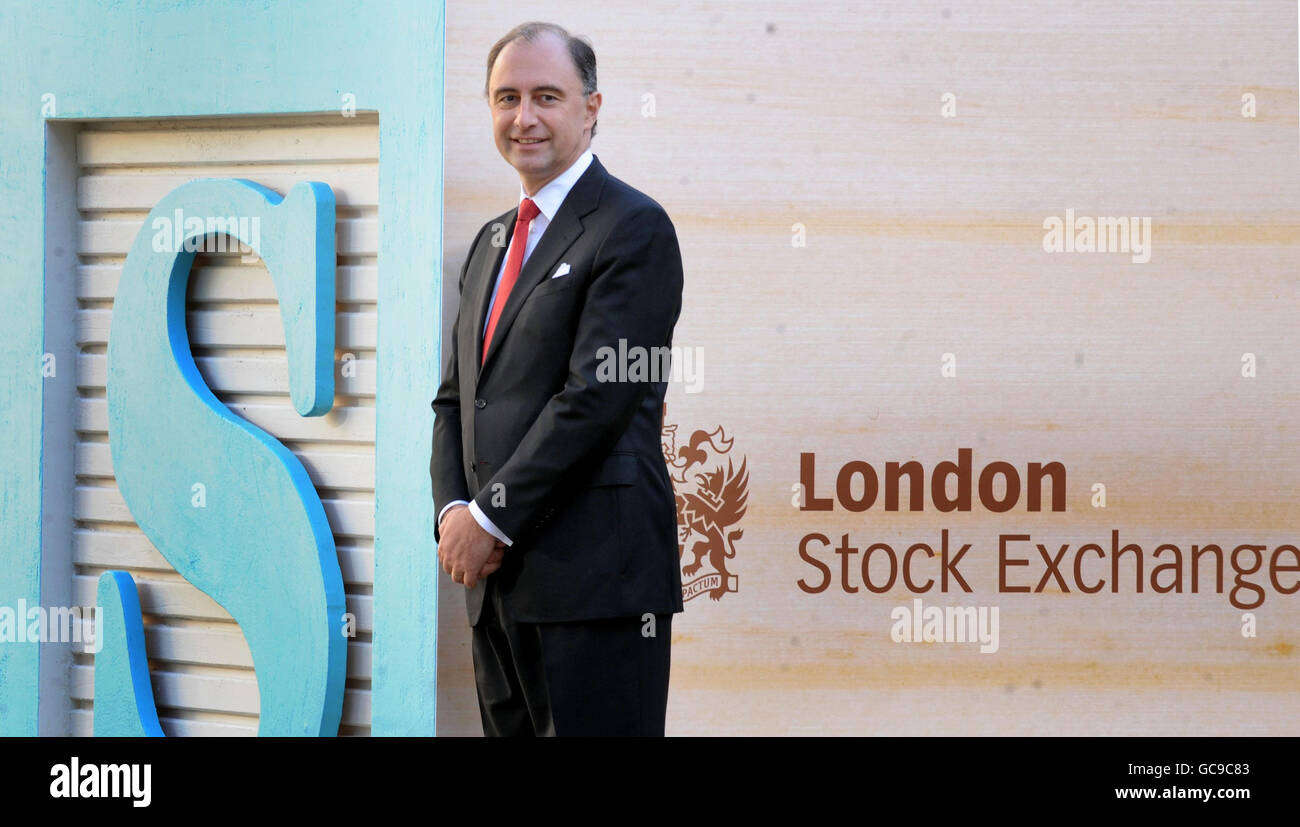 Chief Executive of the LSE, Xavier Rolet, poses bedside signage outside ...