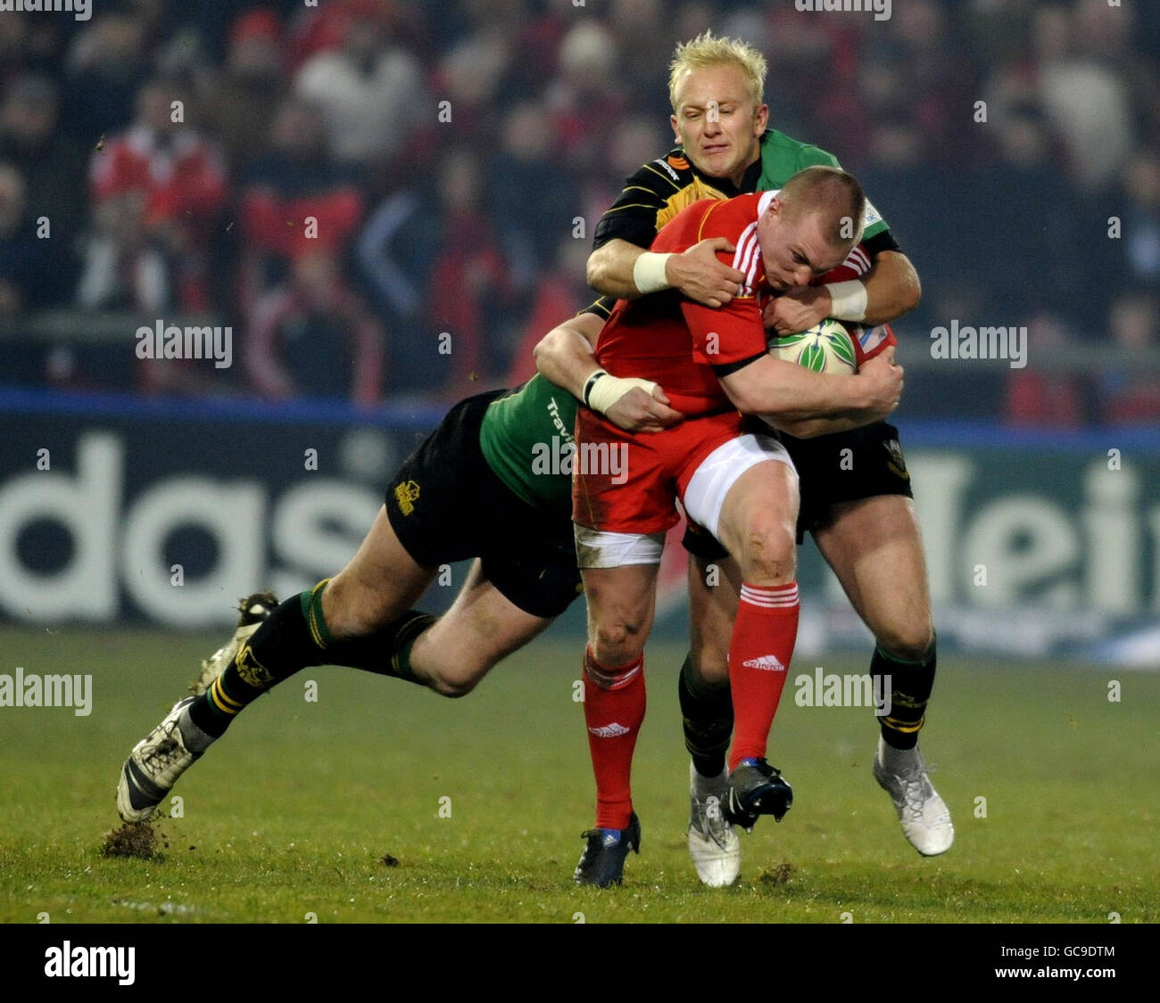 Munster's Keith Earls (centre), Northampton Saints' James Downey (left ...
