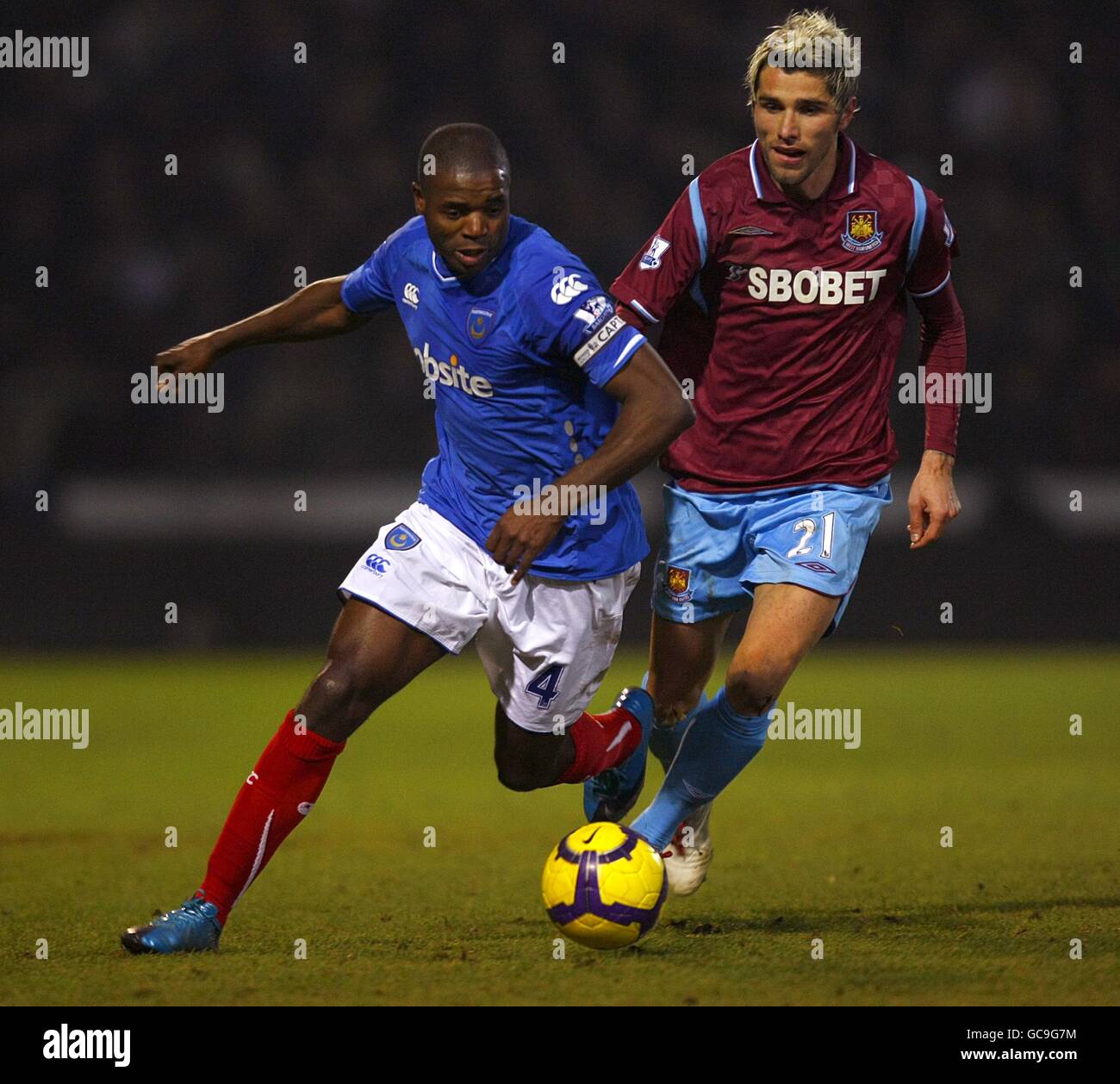 Portsmouth's Aaron Mokoena (left) and West Ham United's Valon Behrami ...