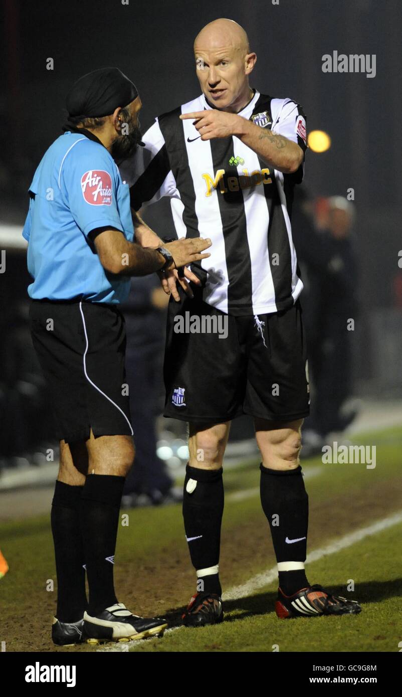 Notts County's Lee Hughes is warned by the referee after kicking the ...