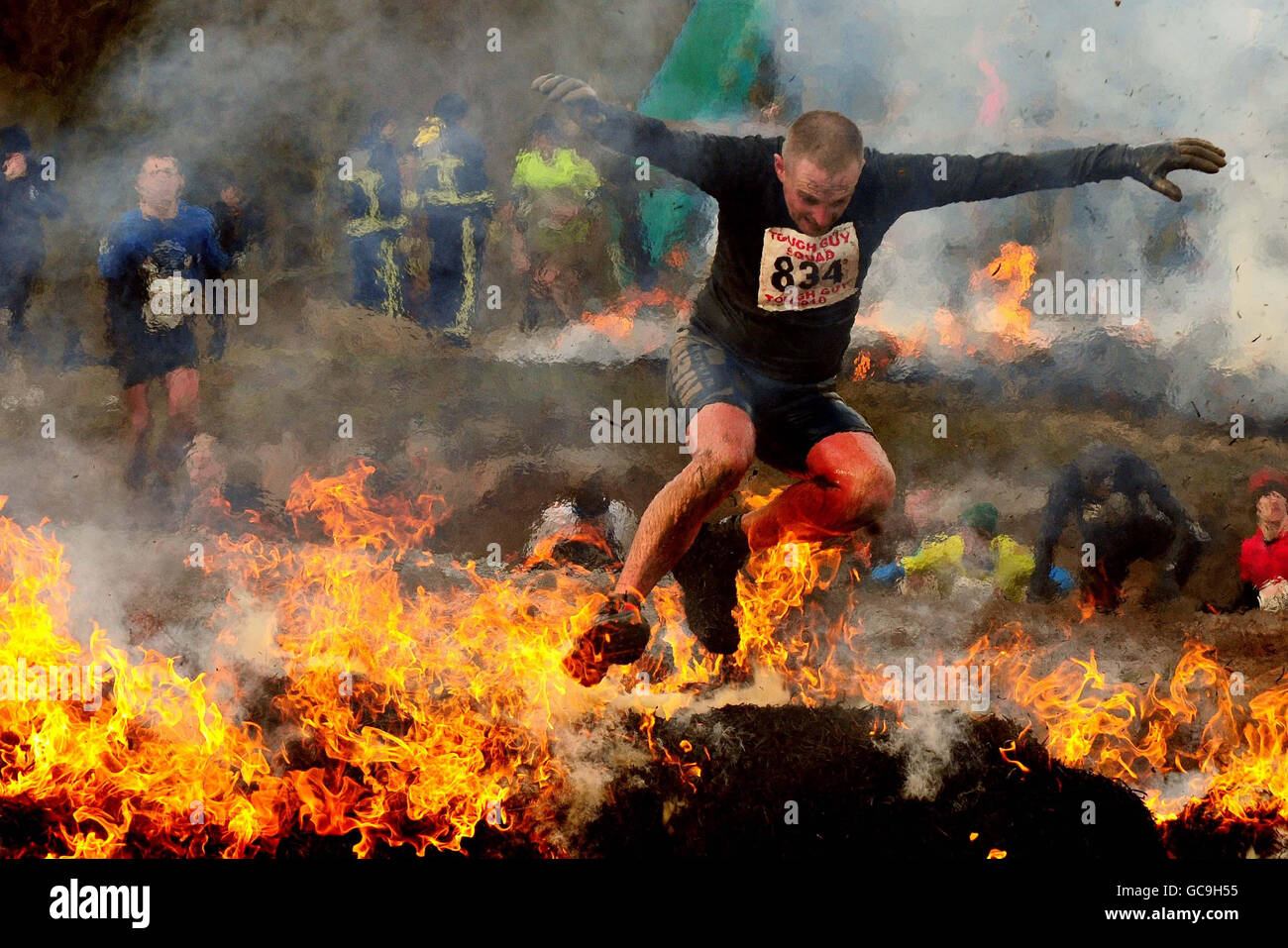 A man competing in the Tough Guy Competition at South Perton Farm ...