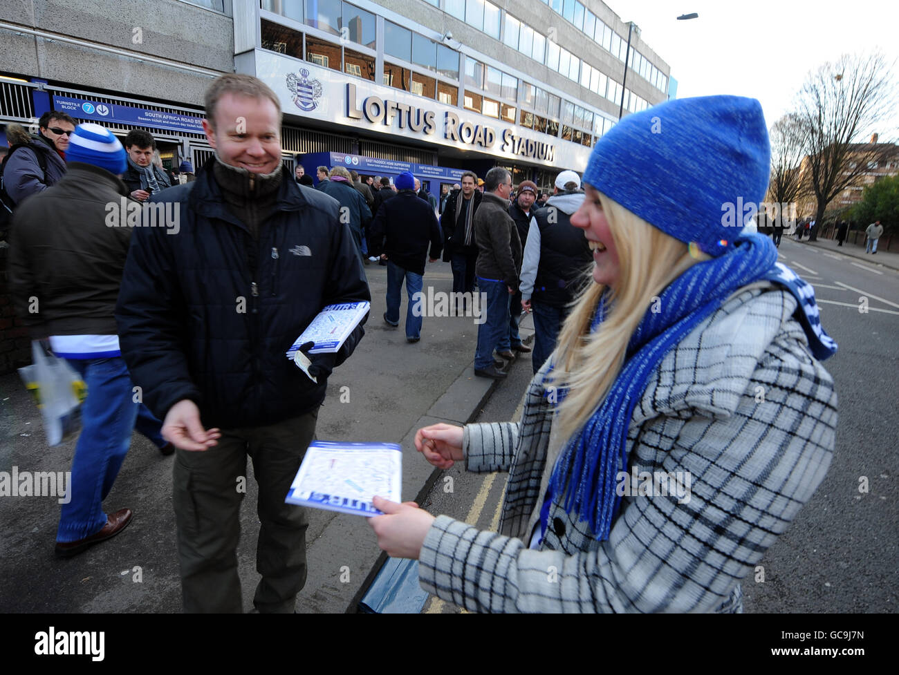 Queens Park Rangers fans buy programmes outside the ground before the ...
