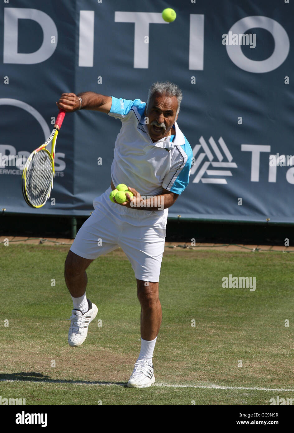 Iranian tennis player Mansour Bahrami serves whilst holding several ...