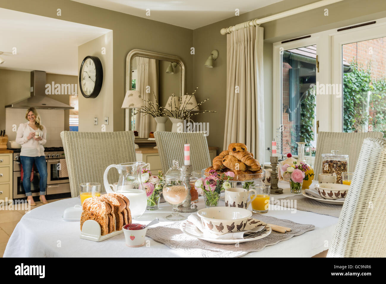 Table laid with breakfast croissant and toast. The dining chairs are ...