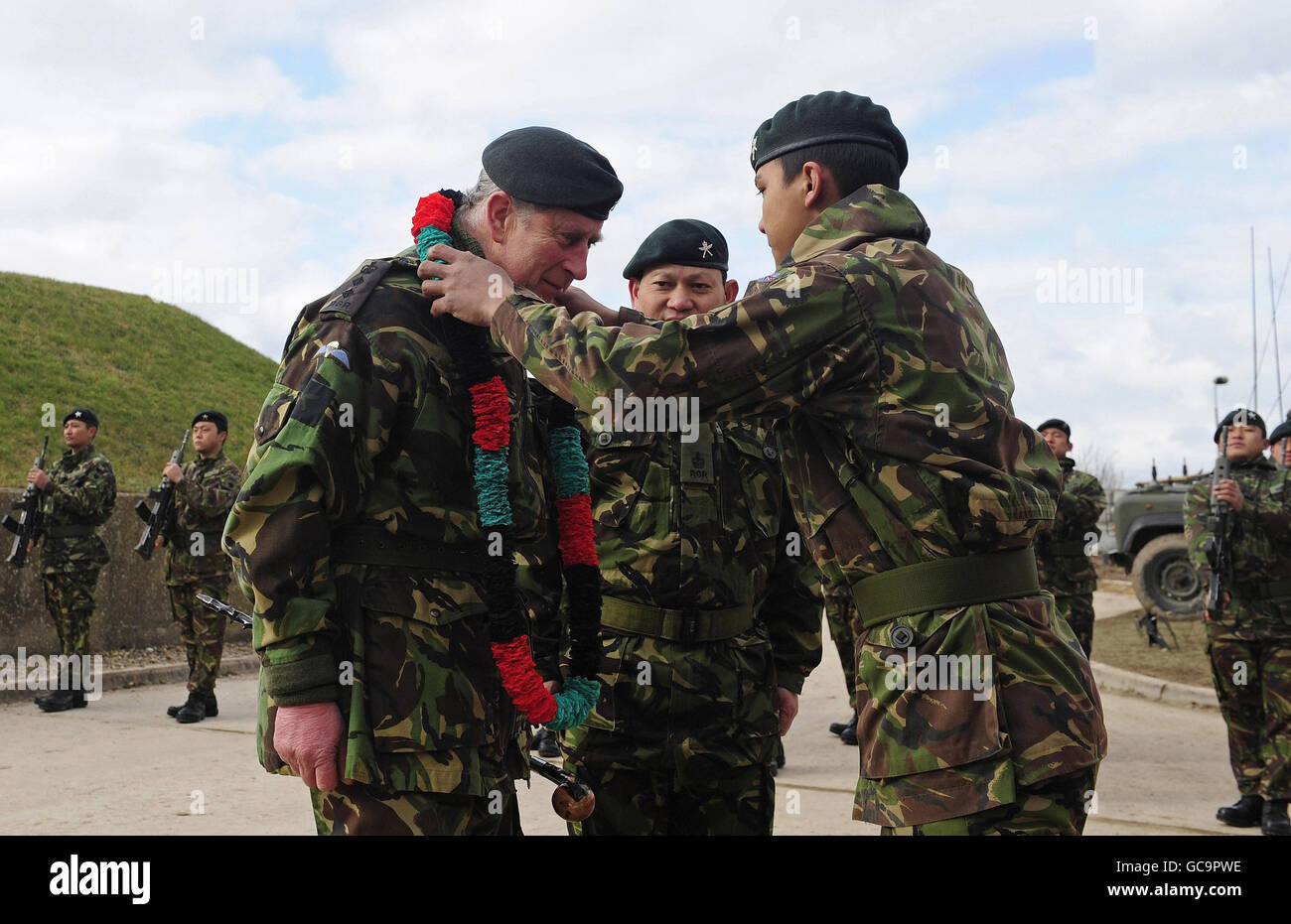 The Prince of Wales receives a garland from a member of the 1st ...