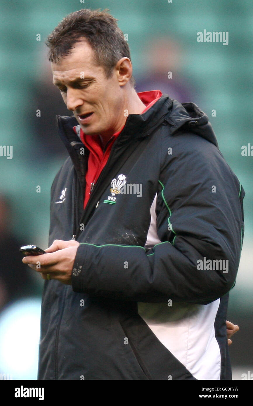 Wales assistant coach Rob Rowley on his mobile phone before the game ...