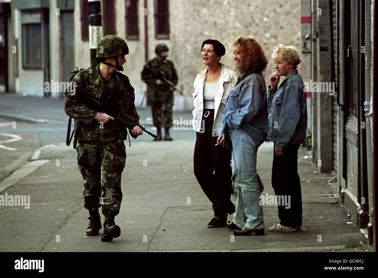 A soldier on patrol on the Falls Road, Belfast, receiving some advice ...