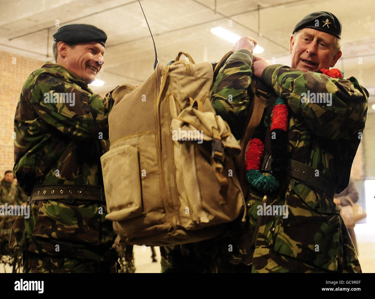The Prince of Wales picks up a kit bag as he meets with members of the ...
