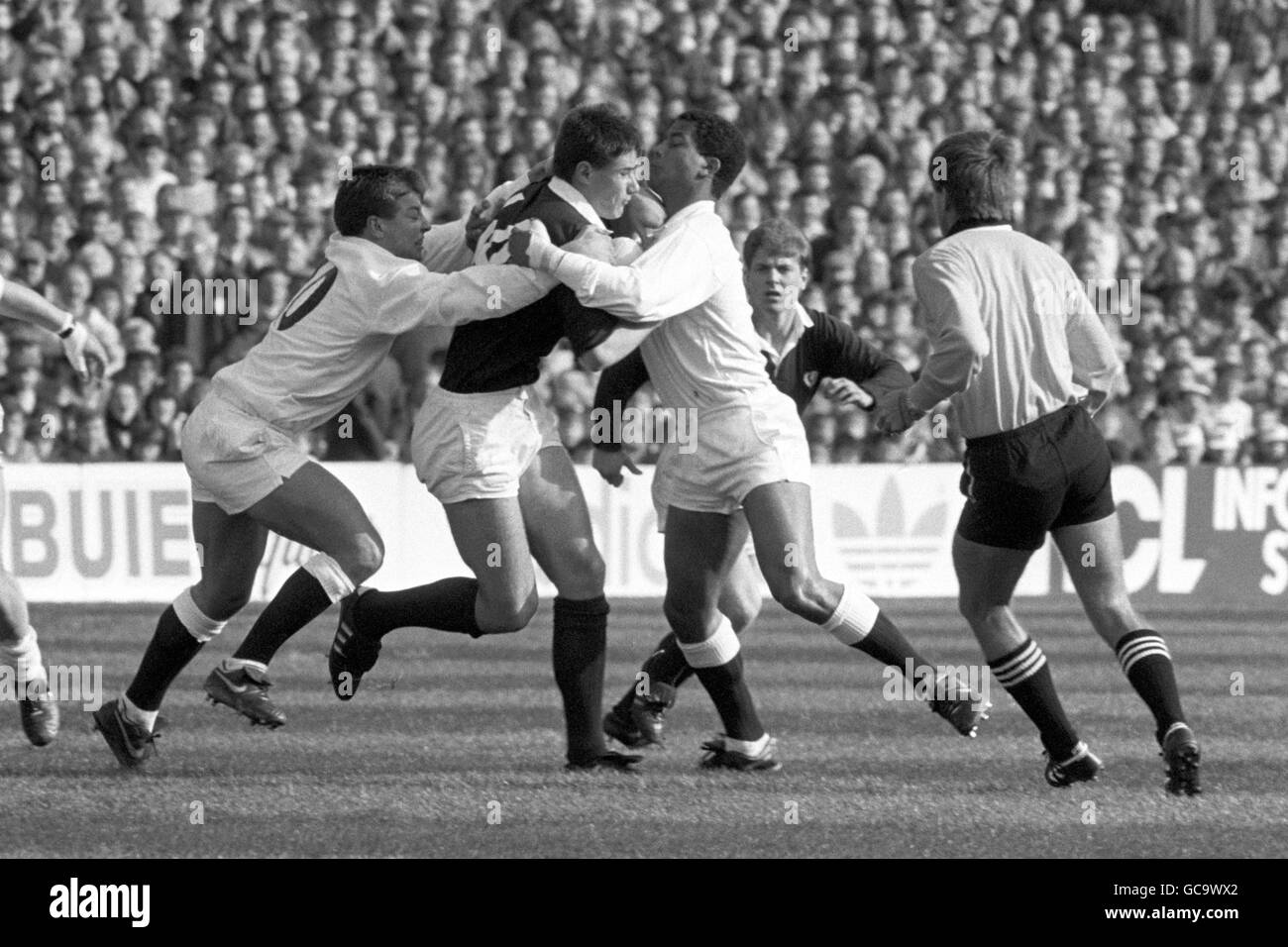 Scotland's Tony Stanger (c) is tackled by England's Rob Andrews (l) and ...
