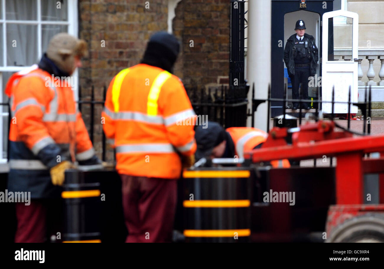 A police officer looks on as security barrier is erected as final ...