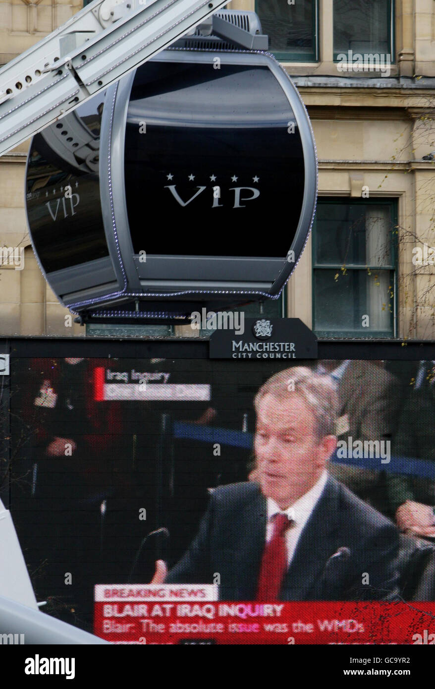 A pod on Manchester's big wheel turns as the large screen in Exchange ...