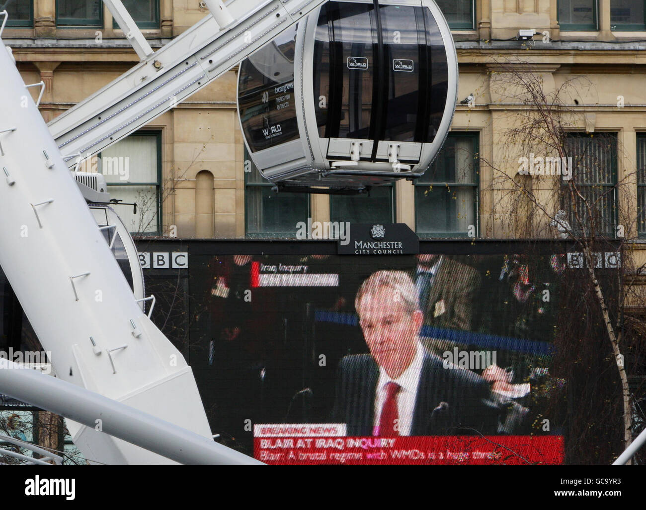 A pod on Manchester's big wheel turns as the large screen in Exchange ...