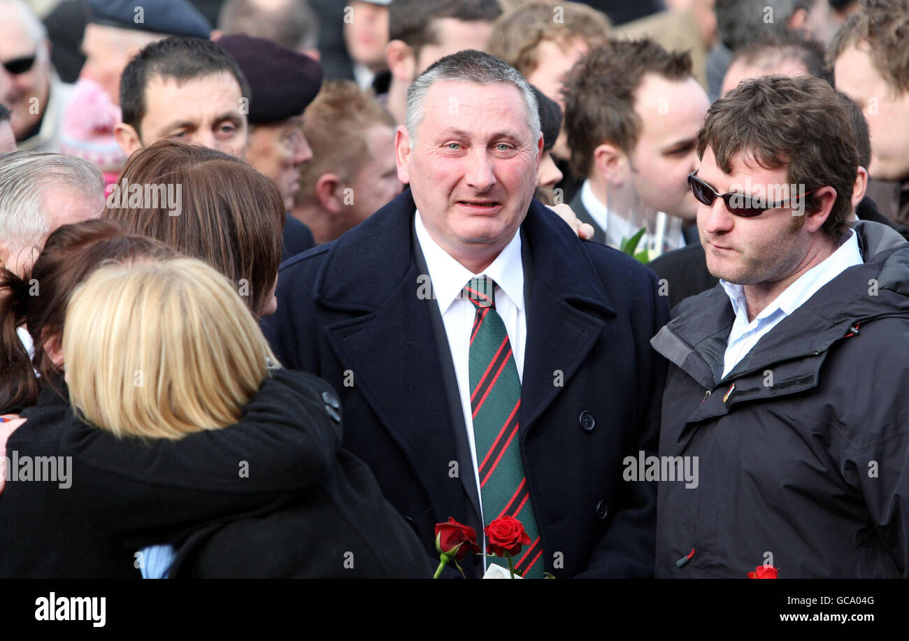 Karl Cooper, (centre) father of Daniel Cooper watches as the coffins of ...