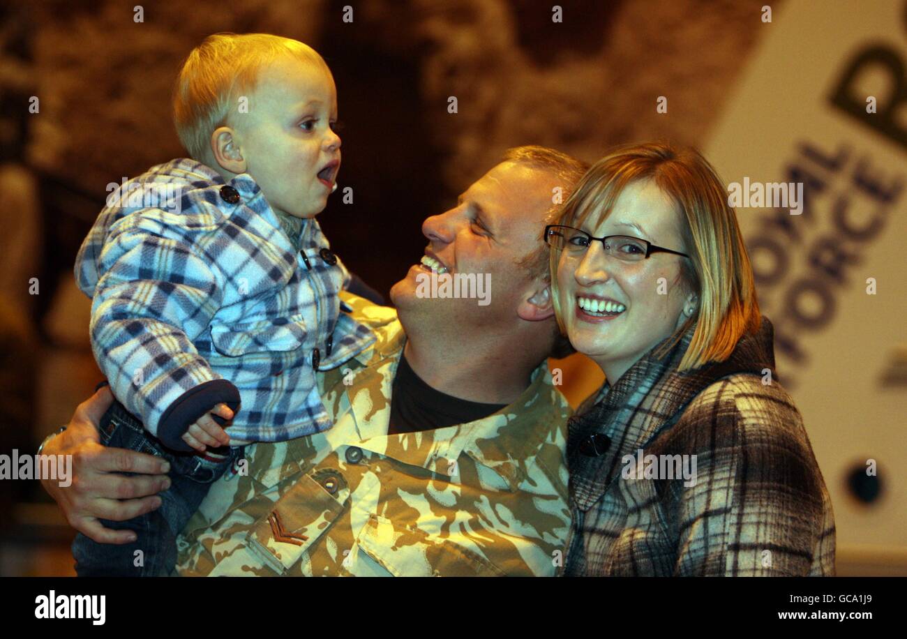Tim Travis of 27 Sqn RAF Regiment is greeted by his wife, Chantelle, and son, Morgan, on his ...